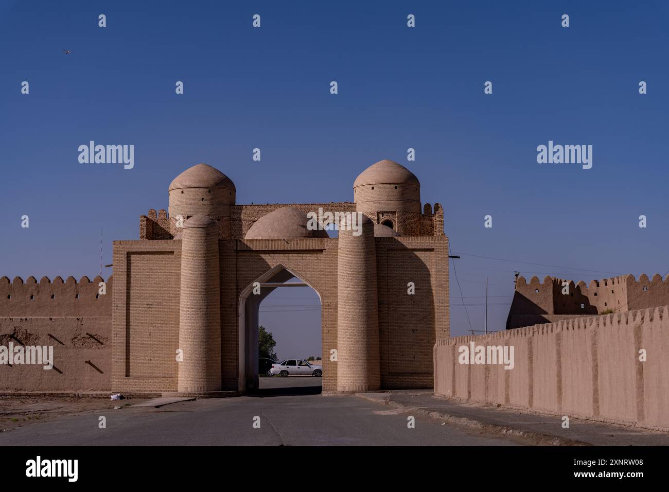 A large archway with two domes is in front of a wall Stock Photo - Alamy