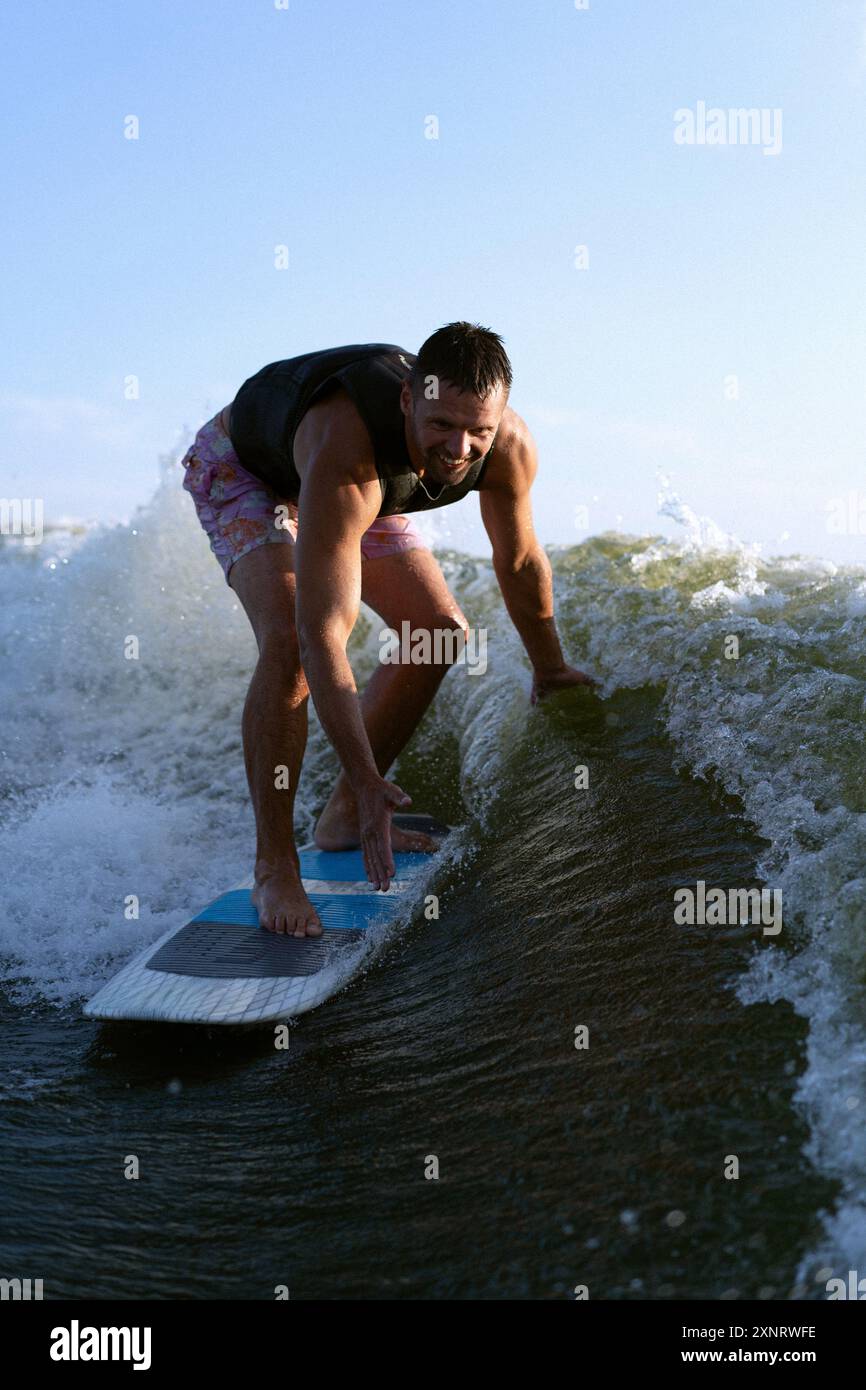Man wakesurfing behind wakeboard boat Stock Photo - Alamy