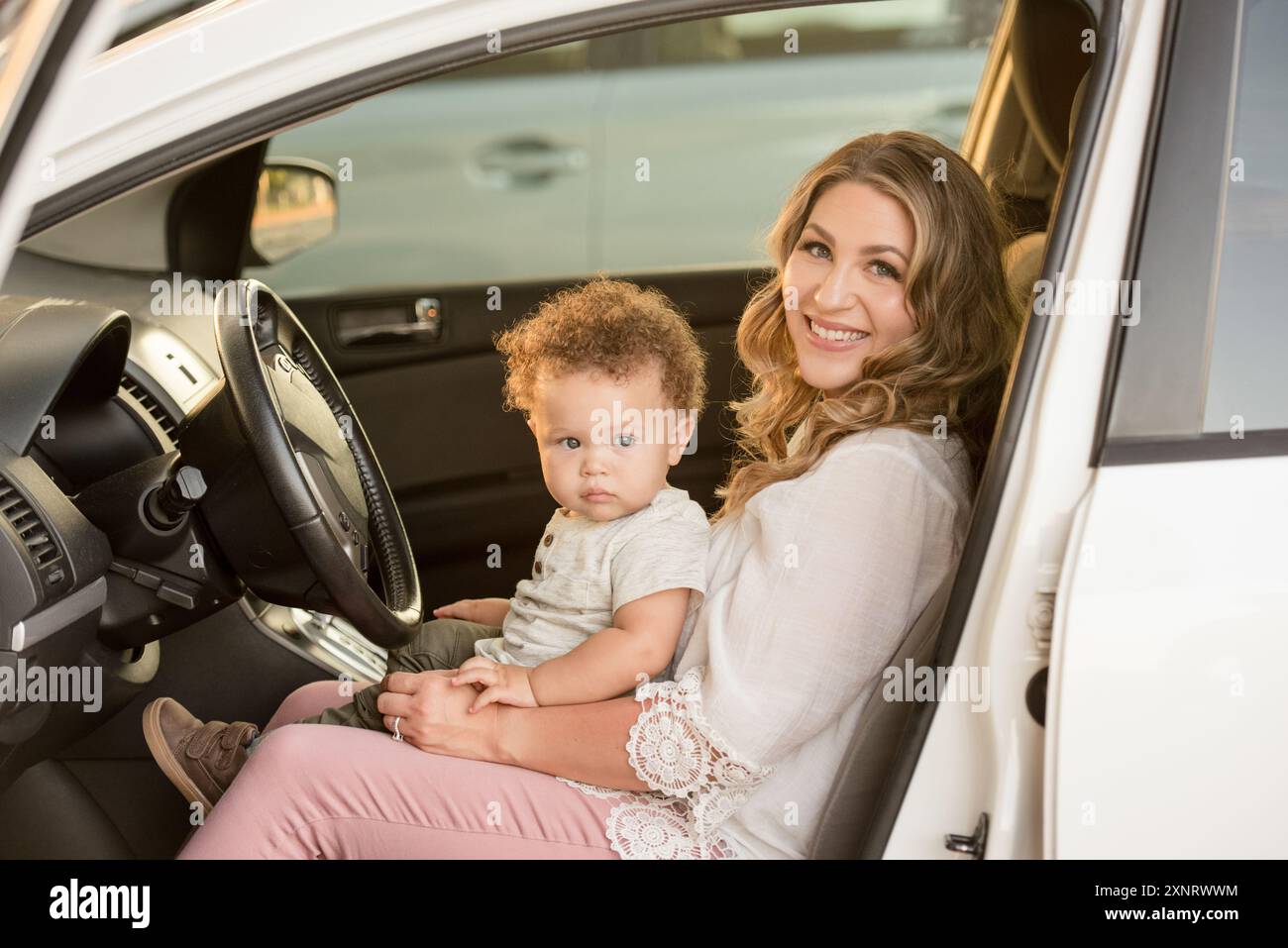 Mother and son sitting in drivers seat of car Stock Photo - Alamy
