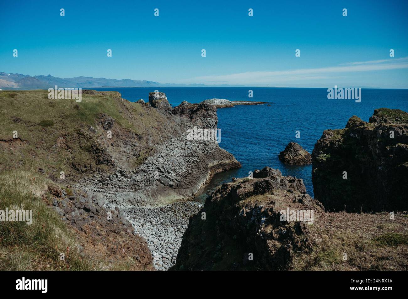 Rugged rocks in Gatklett, Iceland, with clear blue ocean waters Stock ...
