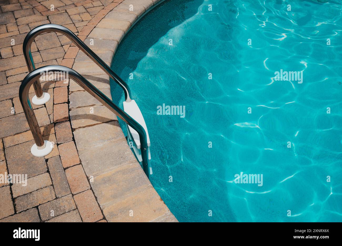 Ladder at edge of empty backyard swimming pool on summer day Stock ...