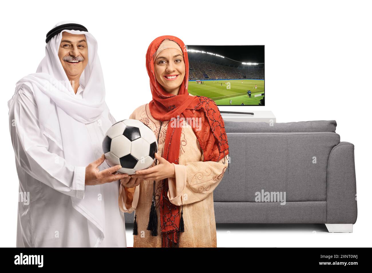 Muslim man and woman holding a football together in front of tv and ...