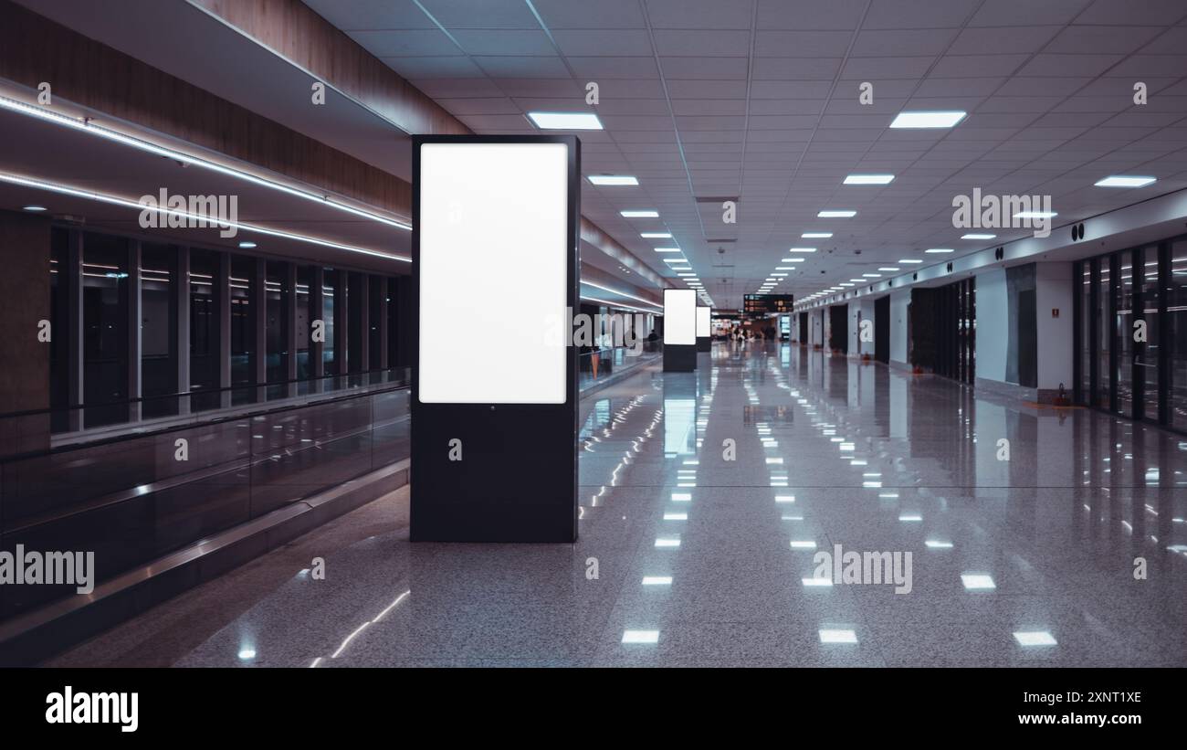 A brightly lit, modern airport terminal with an empty corridor ...