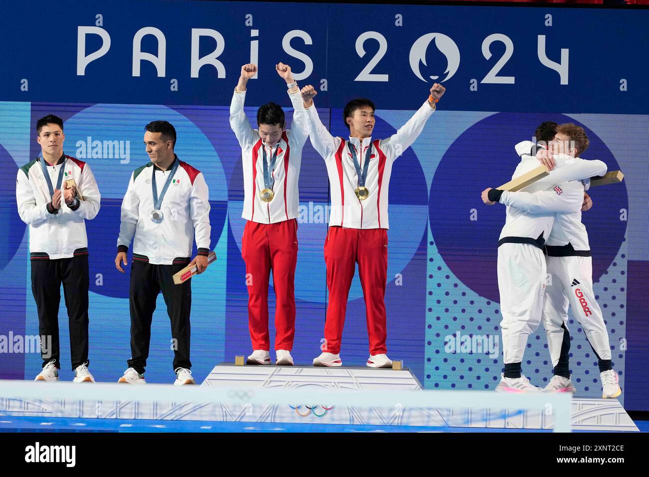 China's Long Daoyi and Wang Zongyuan, center, celebrate their gold ...