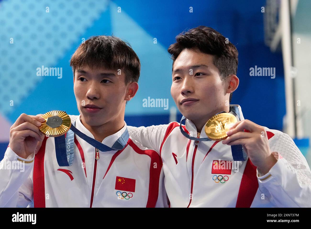 China's Long Daoyi and Wang Zongyuan hold the gold medal on the podium ...