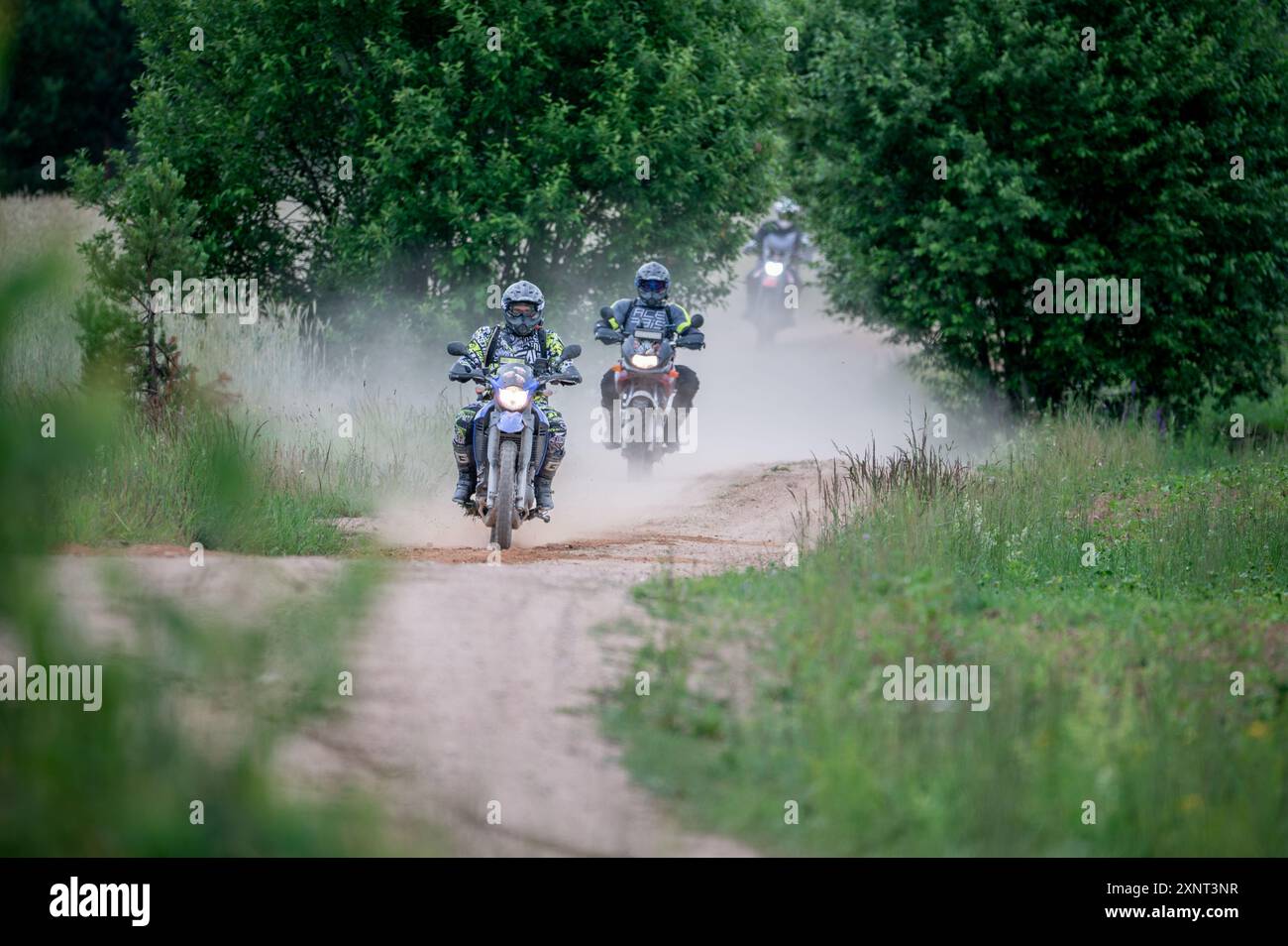 Professional motorcyclist in full moto equipment riding enduro bike in ...