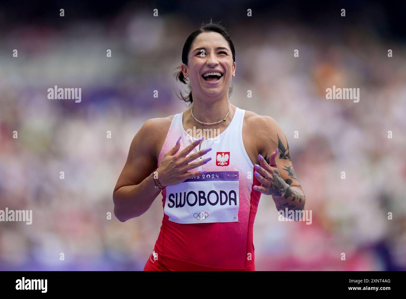 Ewa Swoboda, of Poland, wins a heat in the women's 100-meter run at the ...