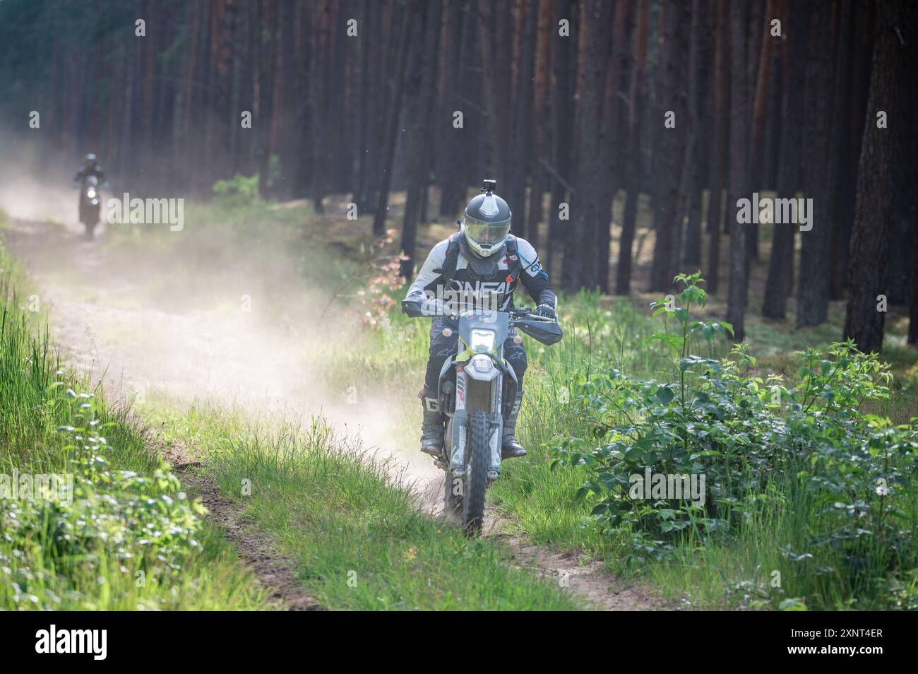 Professional motorcyclist in full moto equipment riding enduro bike in ...
