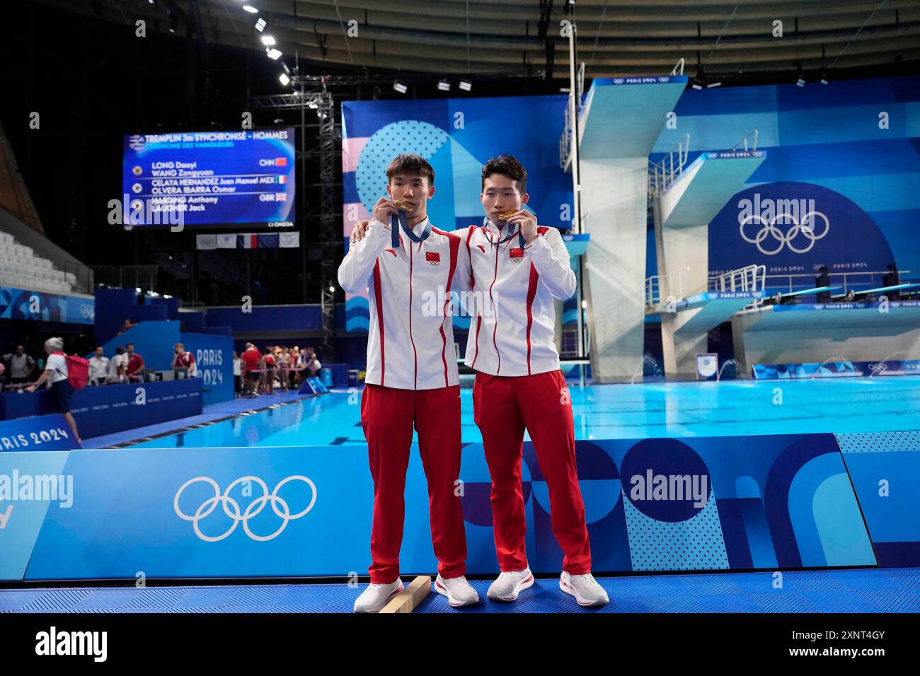 China's Long Daoyi and Wang Zongyuan hold the gold medal on the podium ...
