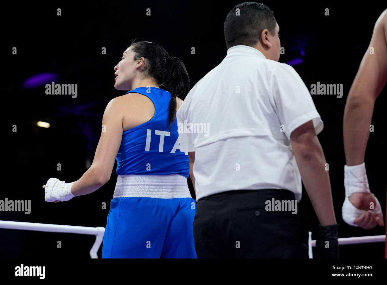Italy's Angela Carini speaks with her corner in after abandoning her ...