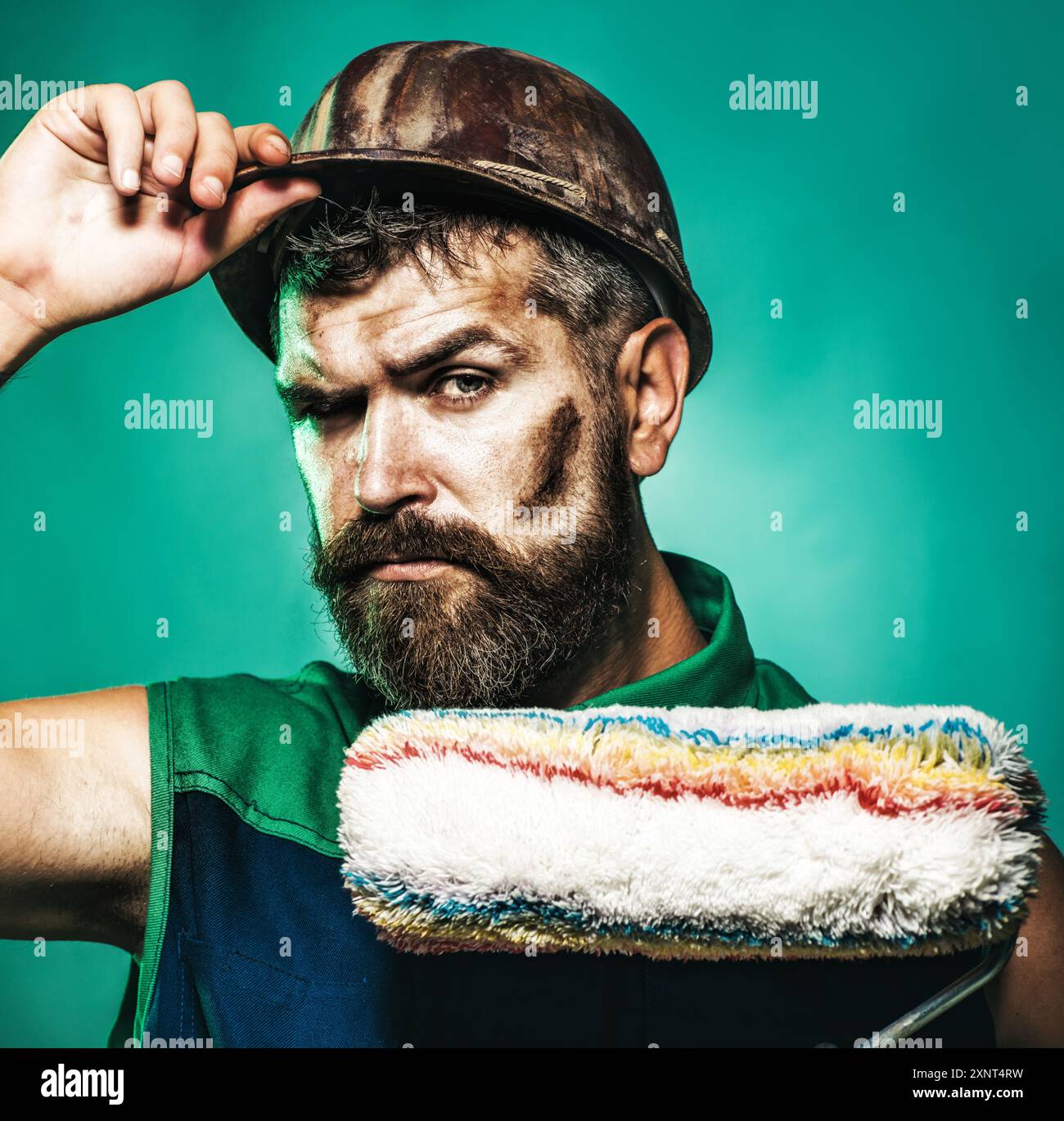 Closeup portrait of painter man with paint roller. Professional painter ...