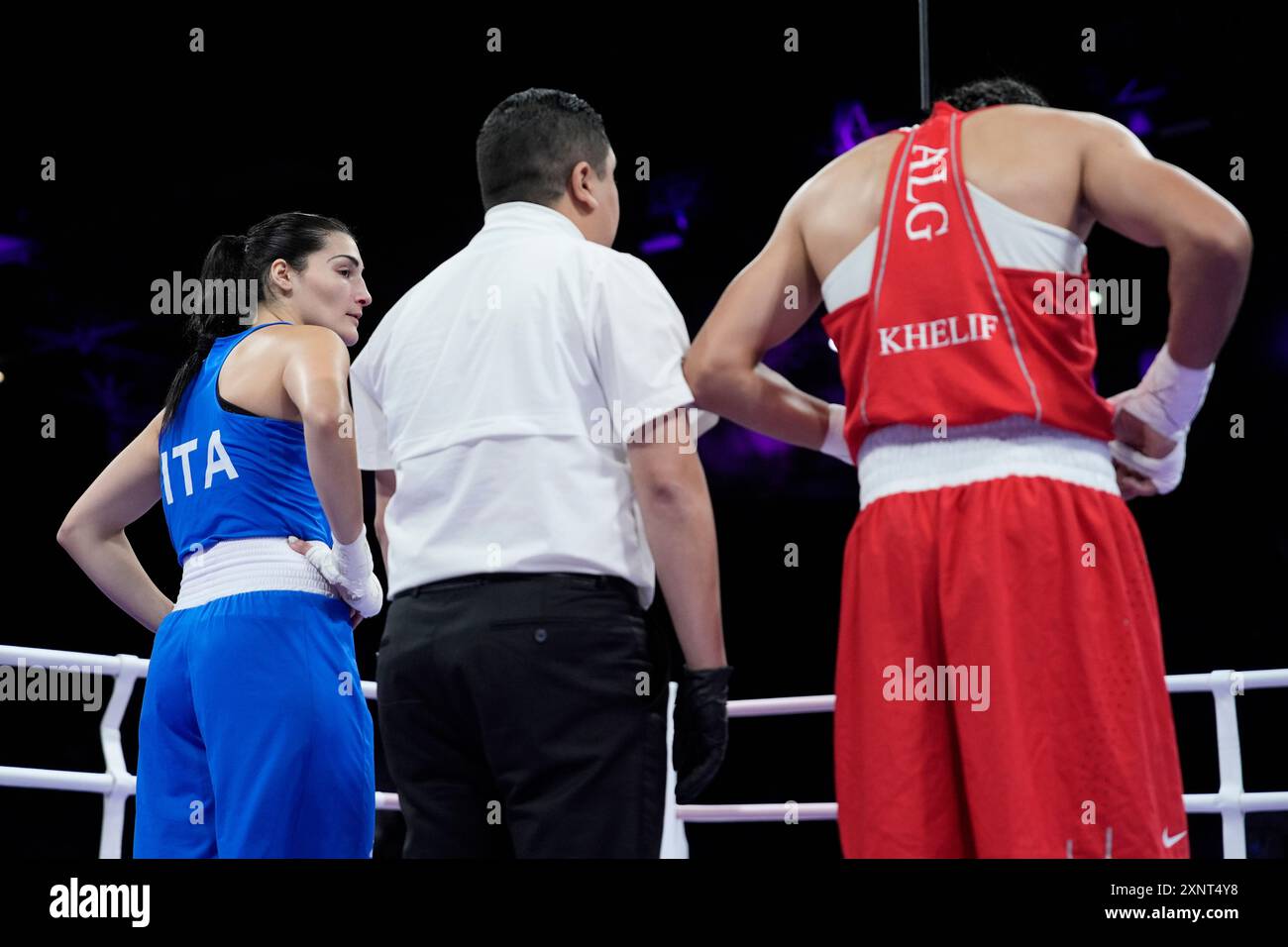 Italy's Angela Carini, left, stands in the ring after abandoning her ...