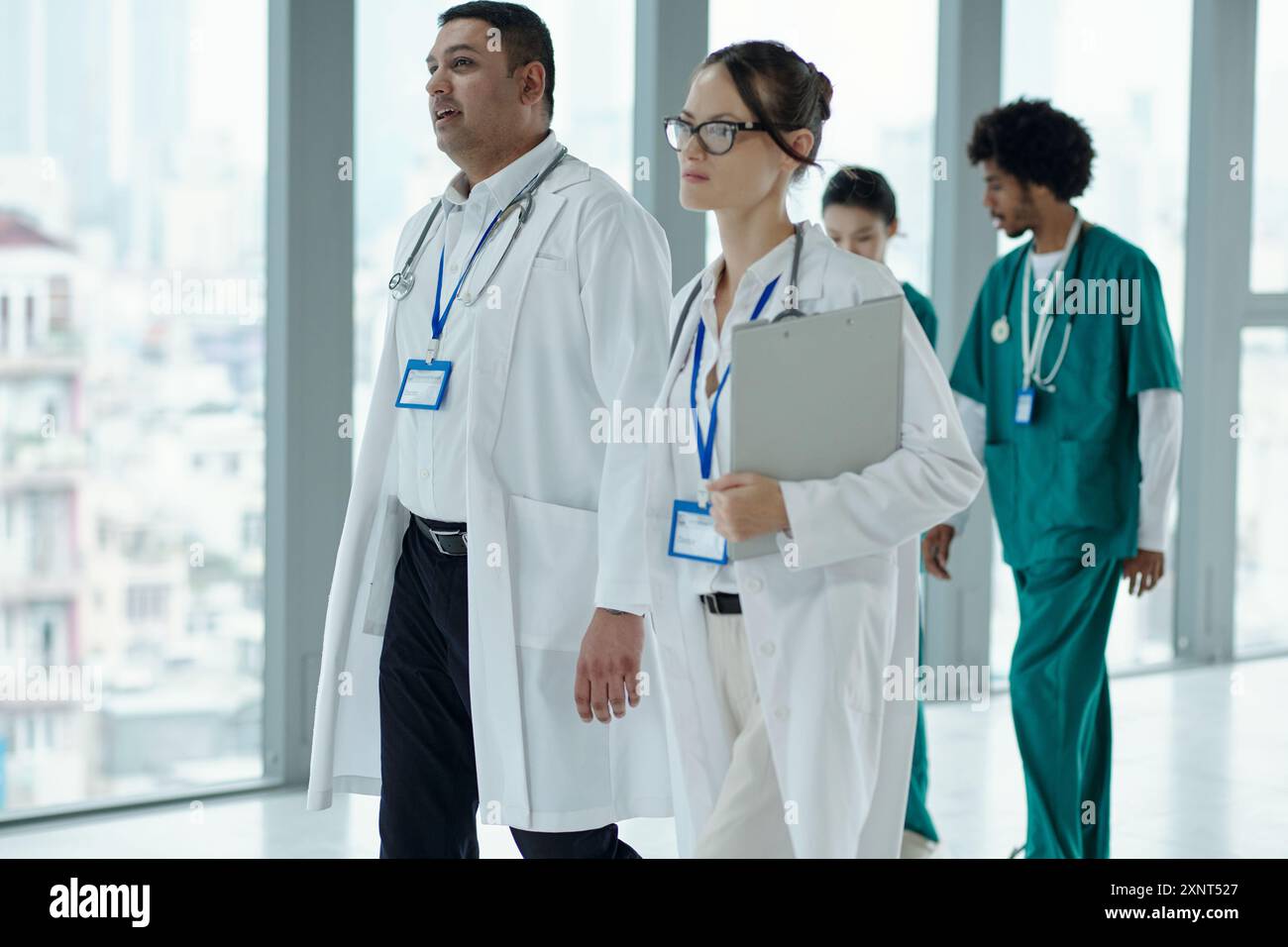 Doctors Walking Along The Hospital Corridor Stock Photo - Alamy