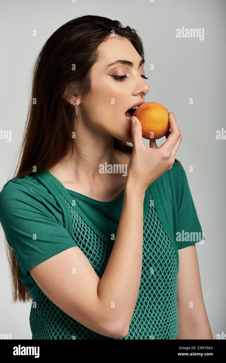 Beautiful young model bites fruit hi-res stock photography and images ...