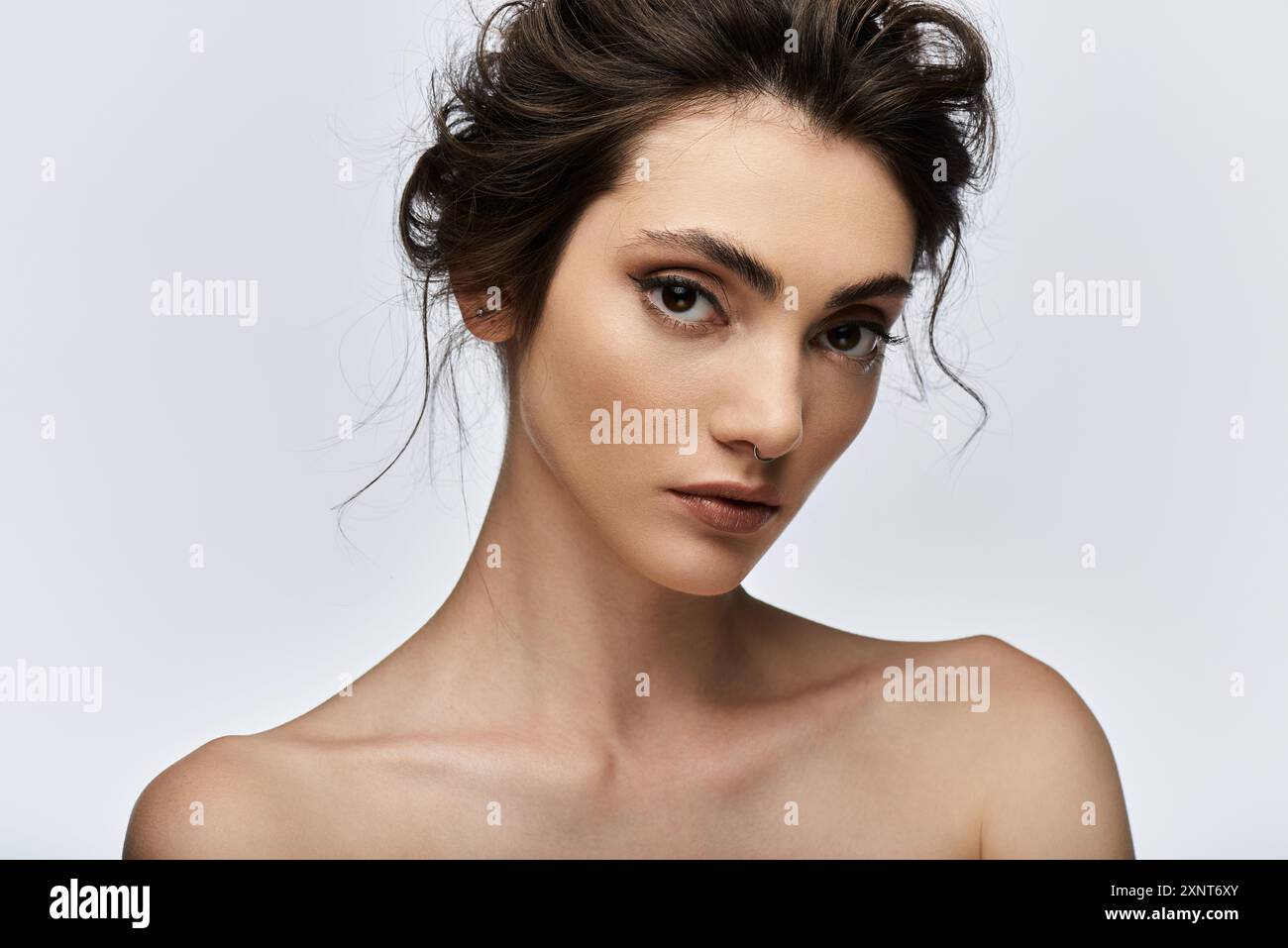 A young woman with dark hair stares intensely at the camera Stock Photo ...