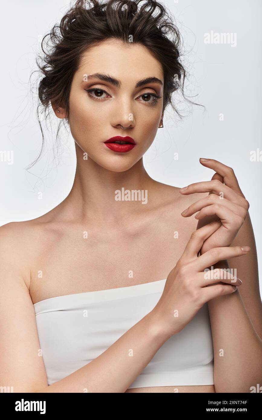 A young woman poses for a portrait in a simple white top Stock Photo ...