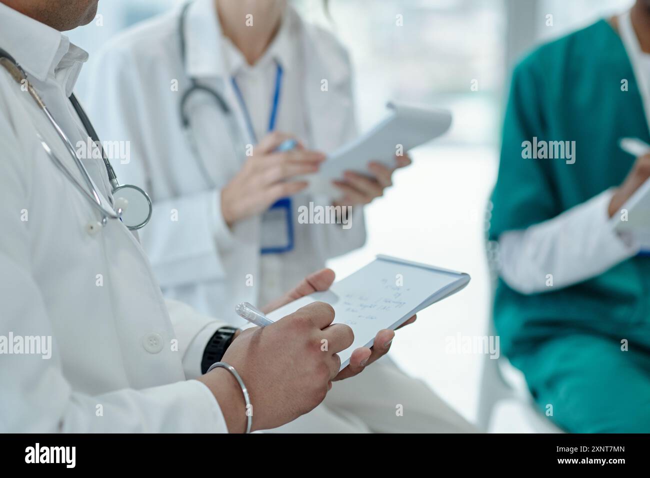 Doctor Making Notes At Training Stock Photo - Alamy
