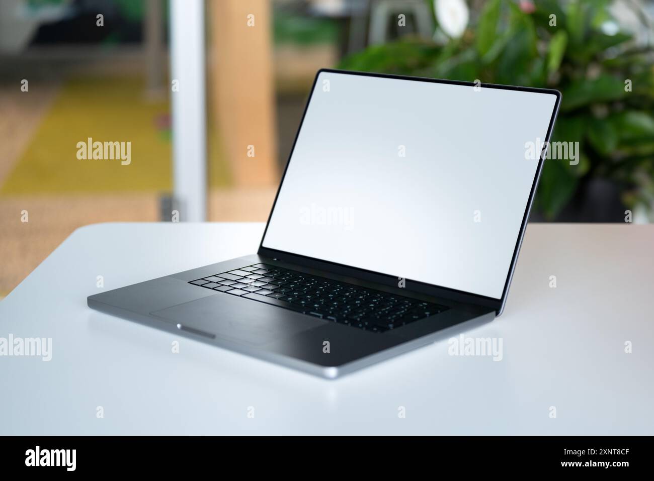 Laptop blank screen mockup. Office table interior Stock Photo - Alamy