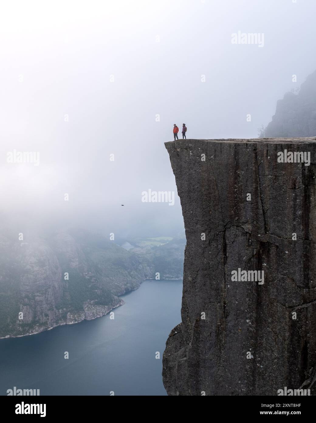 Two hikers marvel at the breathtaking view from the edge of a rugged ...