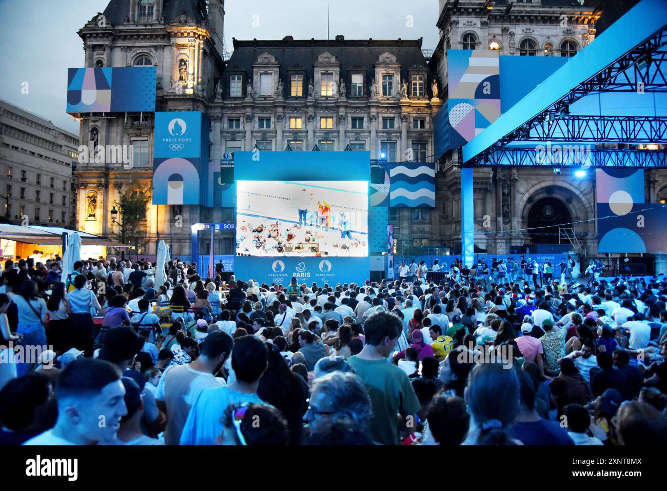 Paris, France. 01st Aug, 2024. Spectators look at a giant screen displayed at an Olympic fan ...