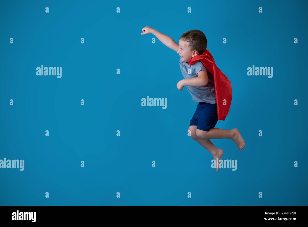 The image of a boy wearing a cape transforms into a hero Stock Photo ...