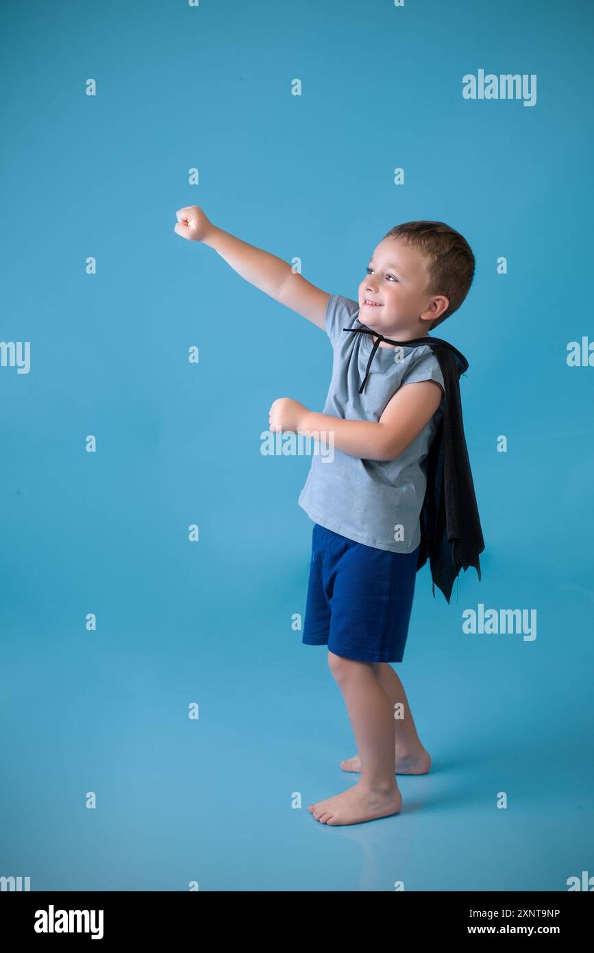 The image of a boy wearing a cape transforms into a hero Stock Photo ...
