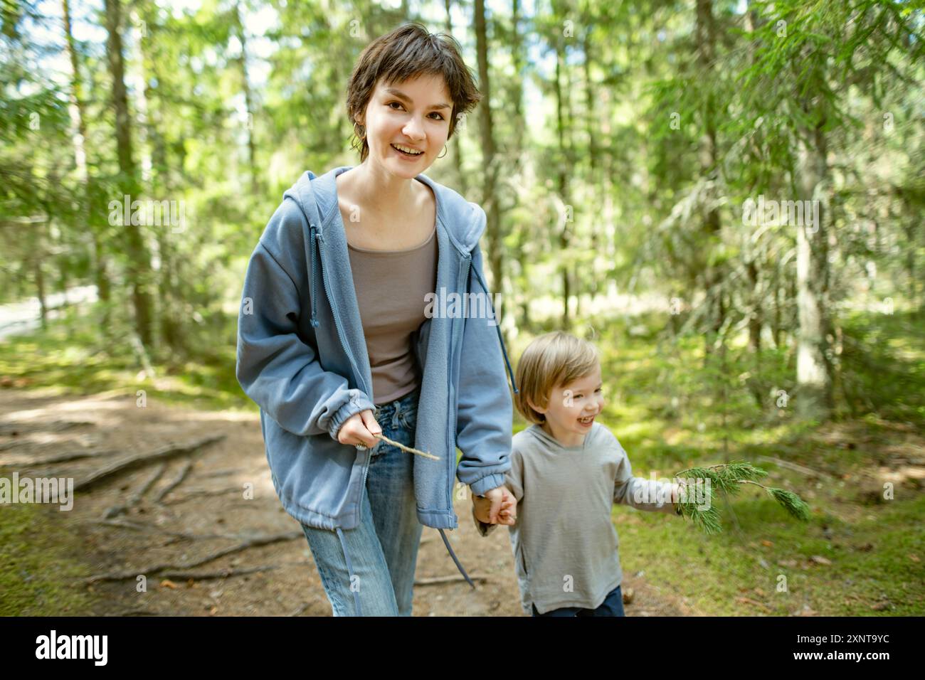 Teenage girl and her little brother following along a hiking trail in ...