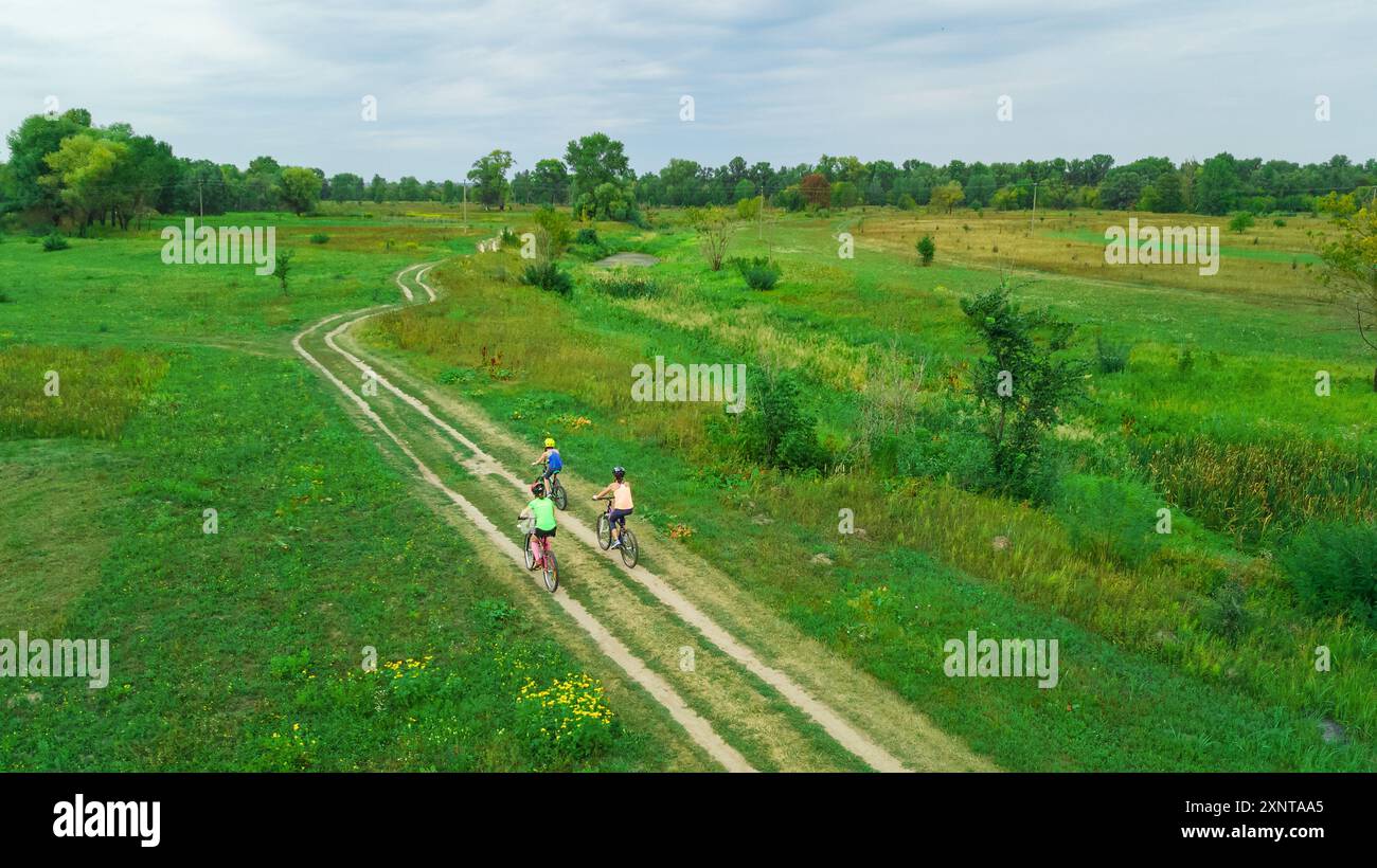 Family cycling on bikes aerial view from above, happy active mother ...