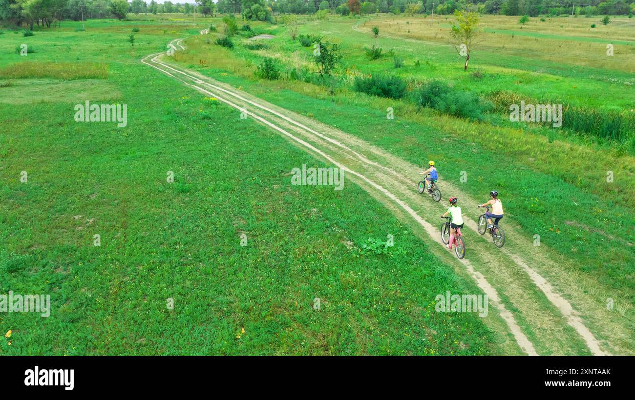 Family cycling on bikes aerial view from above, happy active mother ...