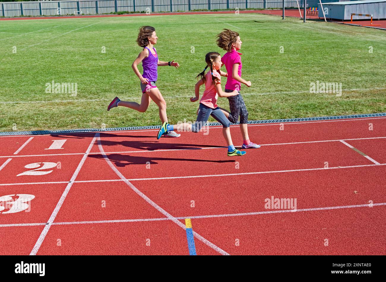 Family fitness, mother and kids running on stadium track, training and ...