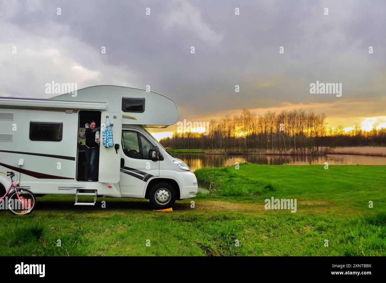 RV camper and woman in camping on sunset, family vacation travel ...