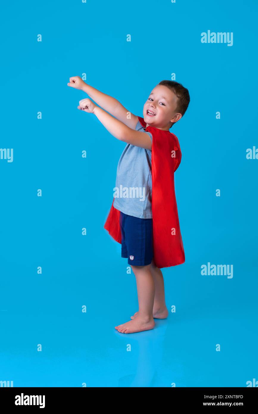 The image of a boy wearing a cape transforms into a hero Stock Photo ...