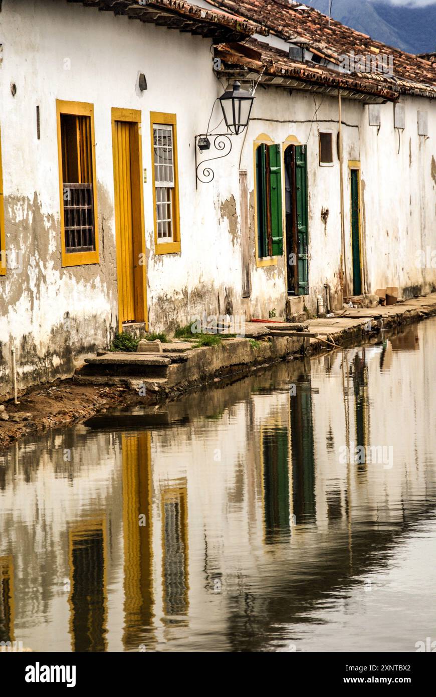 Reflections in the rain. A line of colonial houses in Paraty, Brazil ...