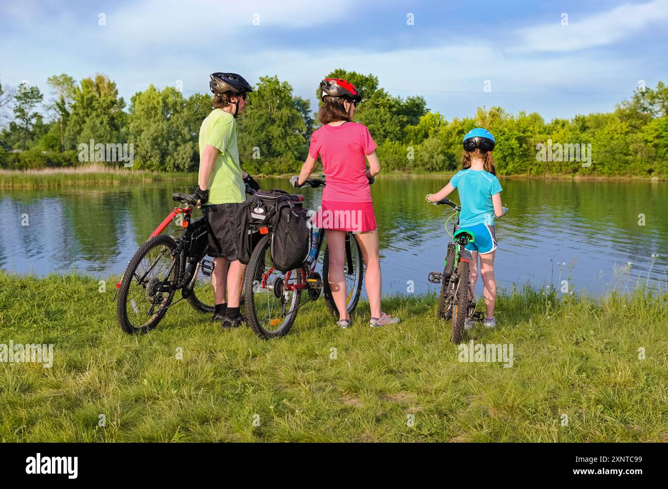 Family bike ride outdoors, active parents and kid cycling and relaxing ...