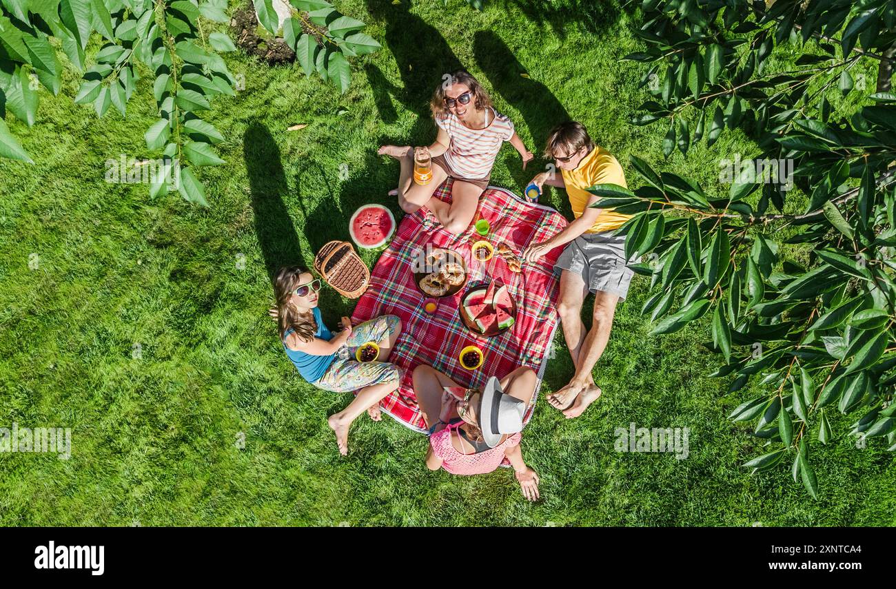 Happy family with children having picnic in park, parents with kids ...