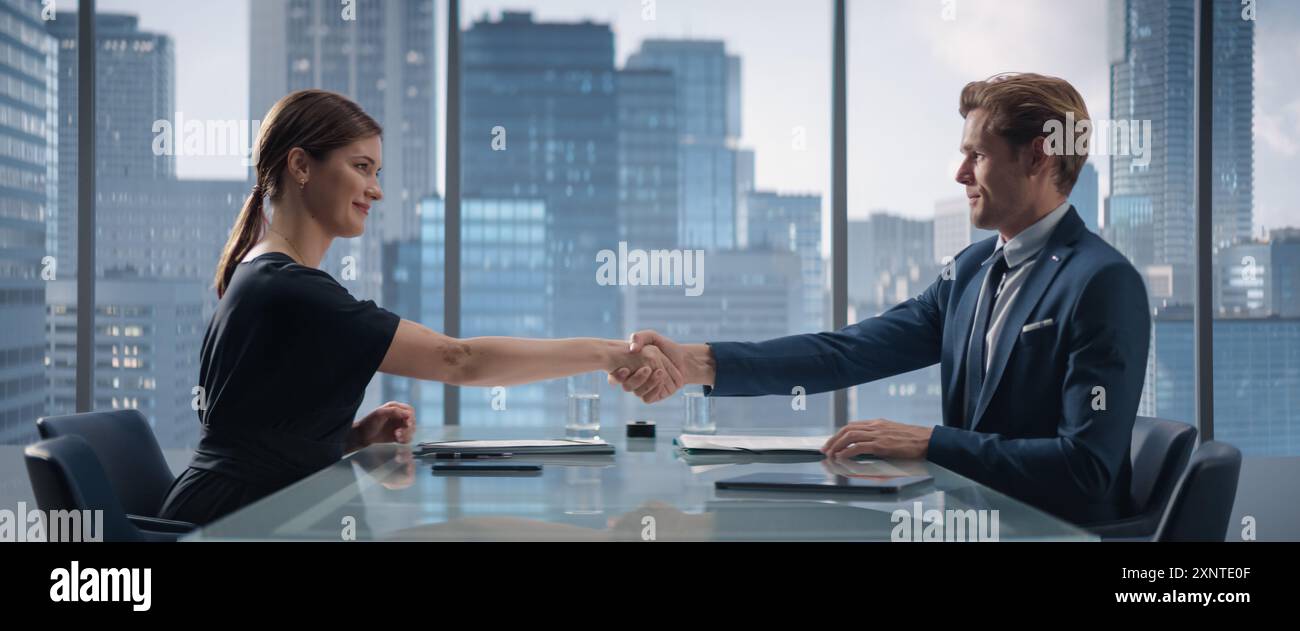 Female and Male Business Partners Sign Successful Deal and Shake Hands ...
