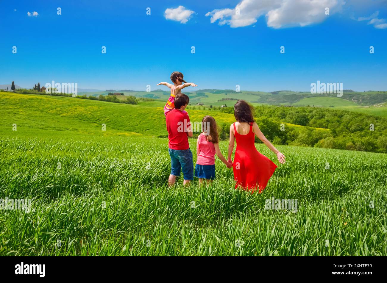 Happy family with children having fun outdoors on green field, spring ...