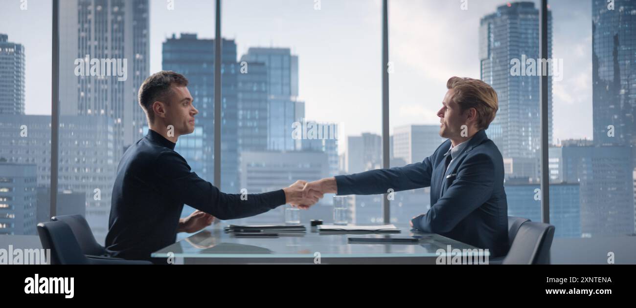 Two Caucasian Businessmen Sitting in Skyscraper Office and Signing ...