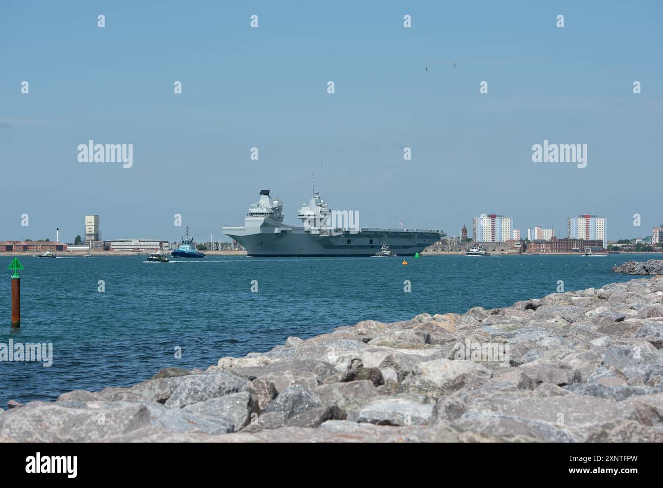 HMS Prince of Wales with her tugs and police escort, departs Portsmouth ...