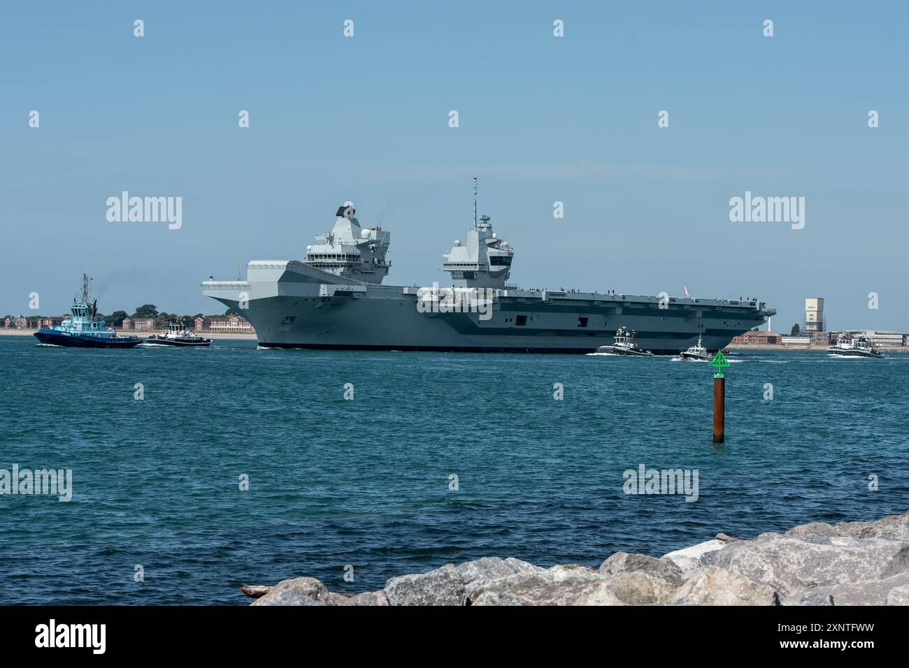 HMS Prince of Wales with her tugs and police escort, departs Portsmouth ...