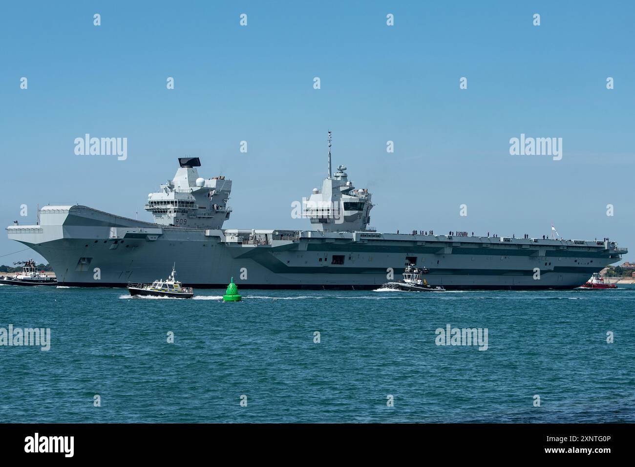 HMS Prince of Wales with her tugs and police escort, departs Portsmouth ...
