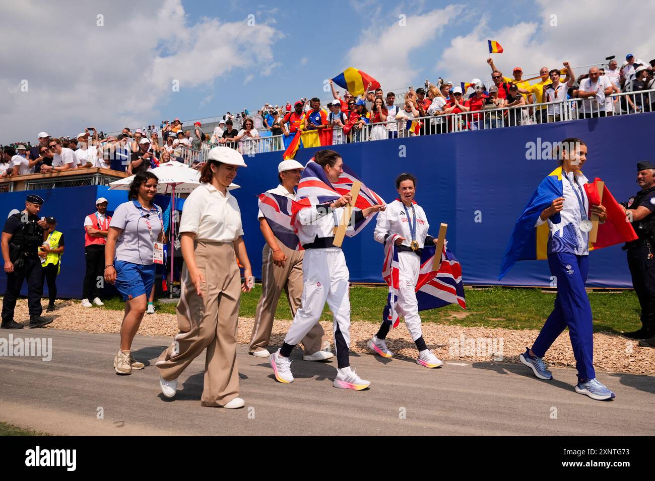 Britain's Emily Craig and Imogen Grant walk with their country's flag ...