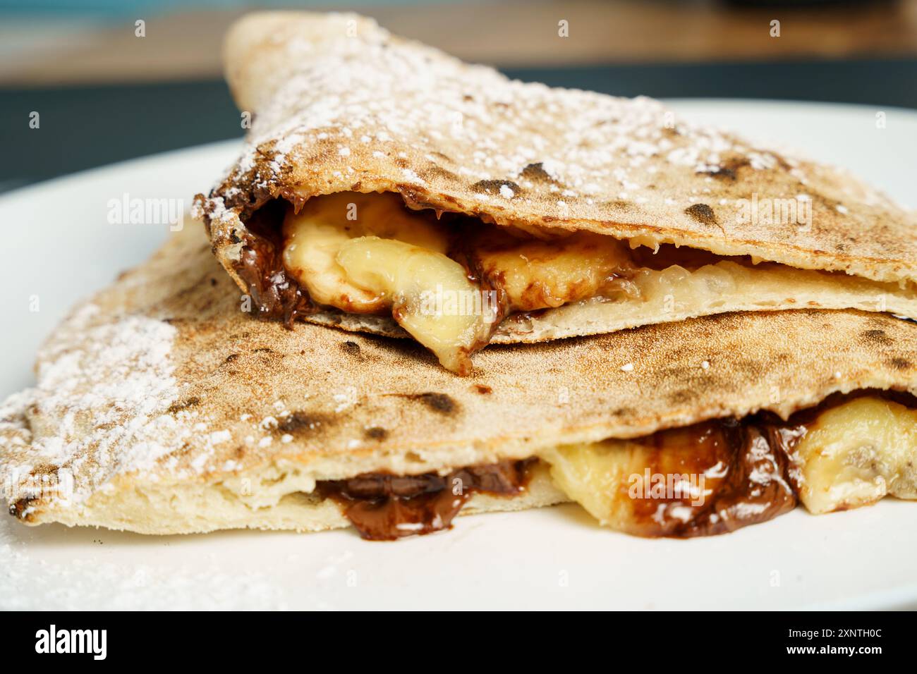 Italian dessert - calzone filled with chocolate, banana and powdered ...
