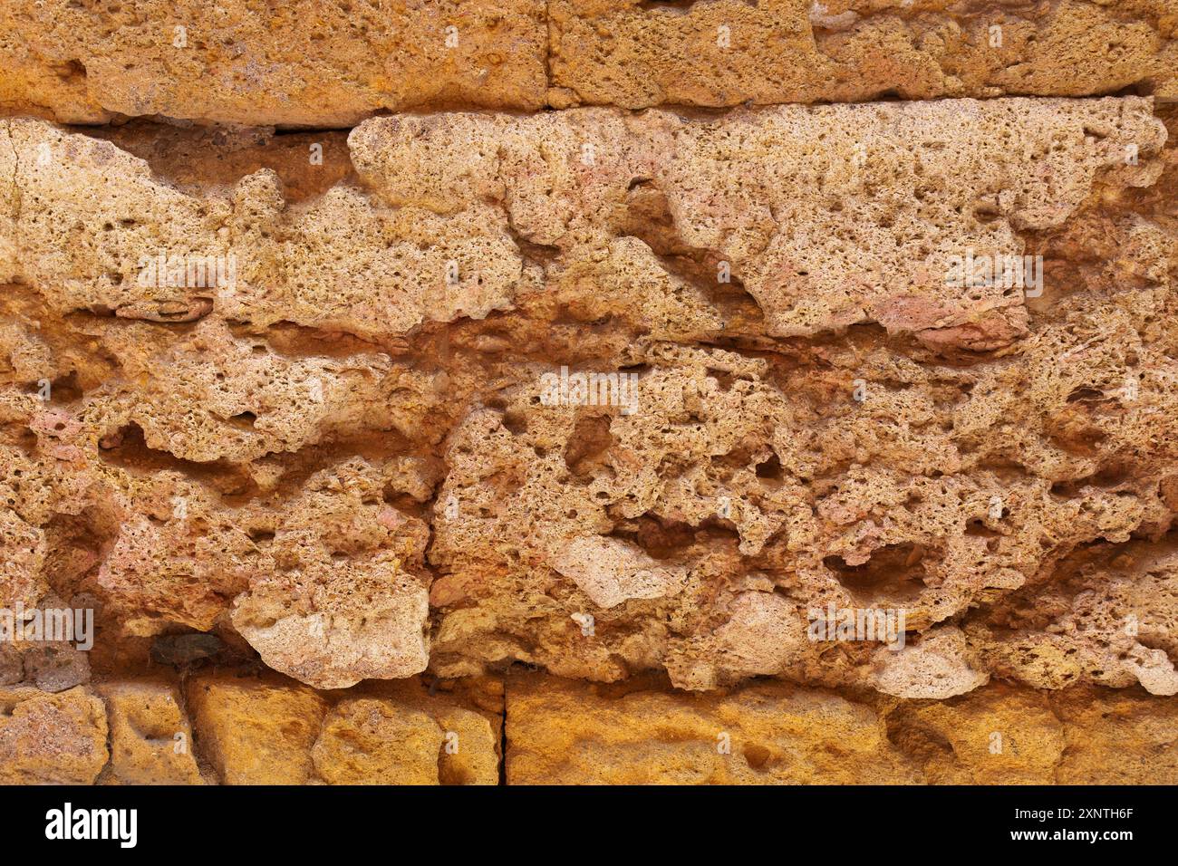 Close-up of a textured wall featuring unique stone patterns Stock Photo ...