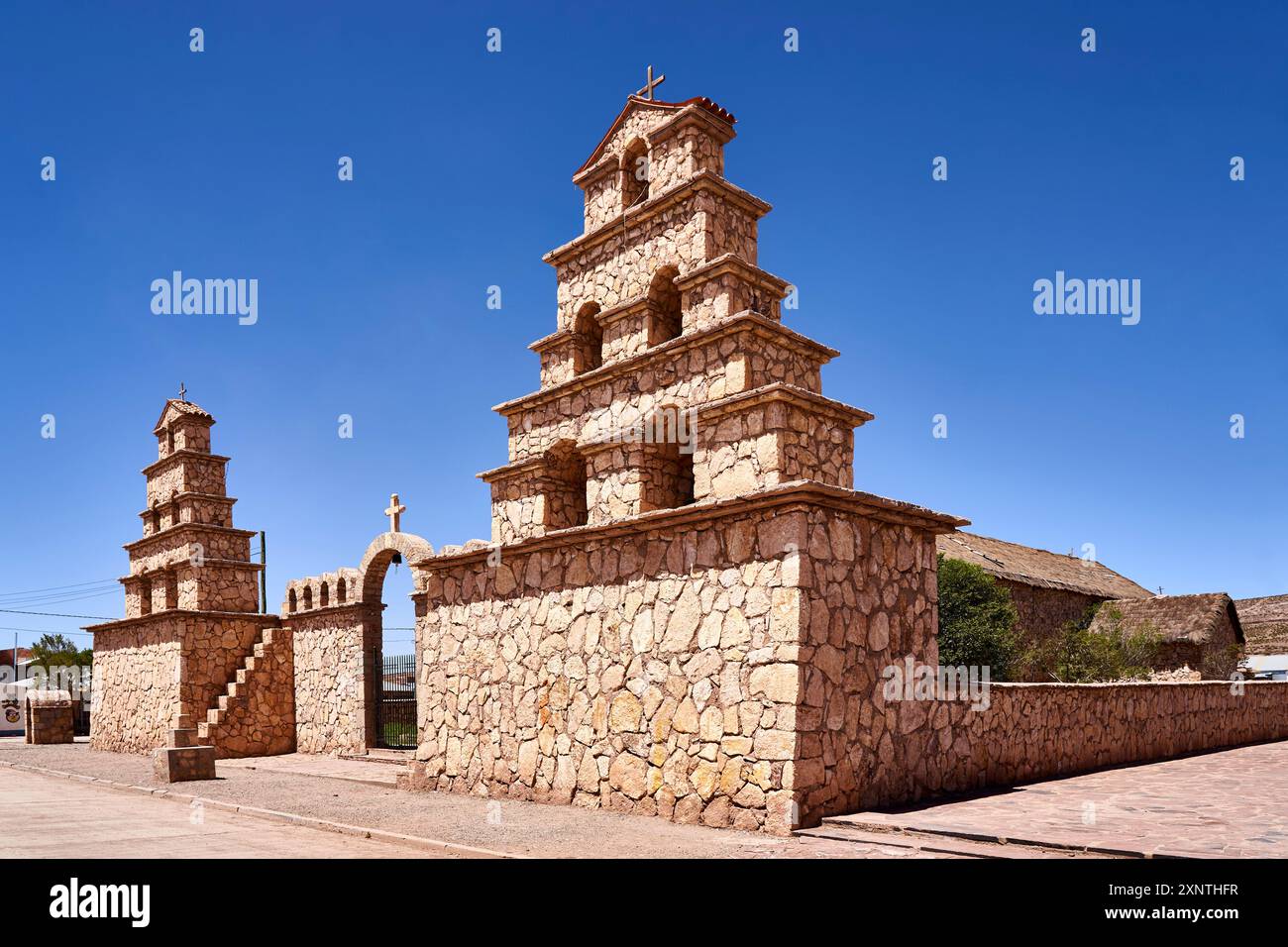 Stone church with detailed architecture and arches under a clear blue ...