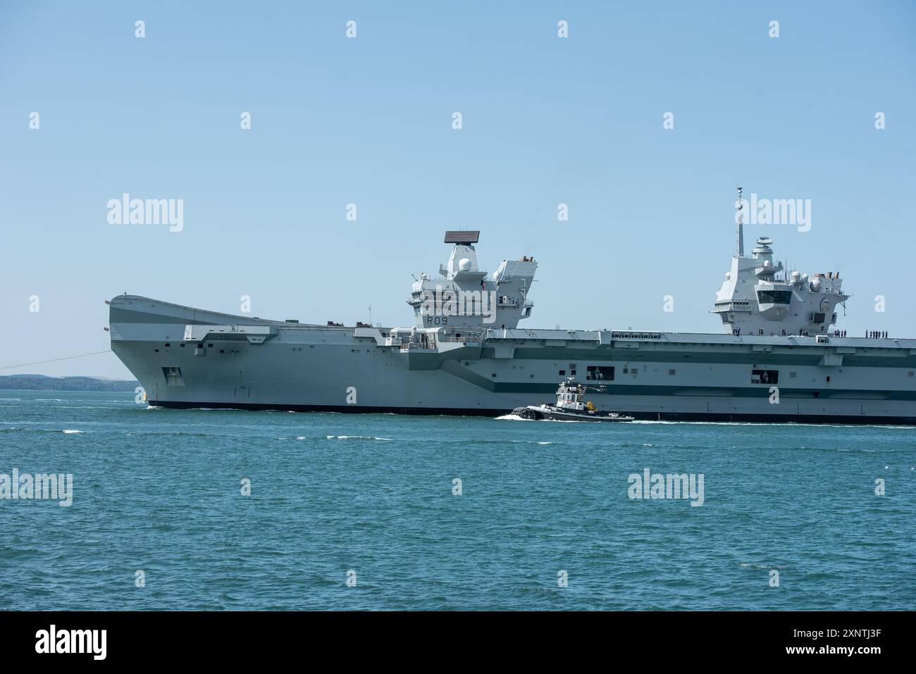 HMS Prince of Wales with her tugs and police escort, departs Portsmouth ...
