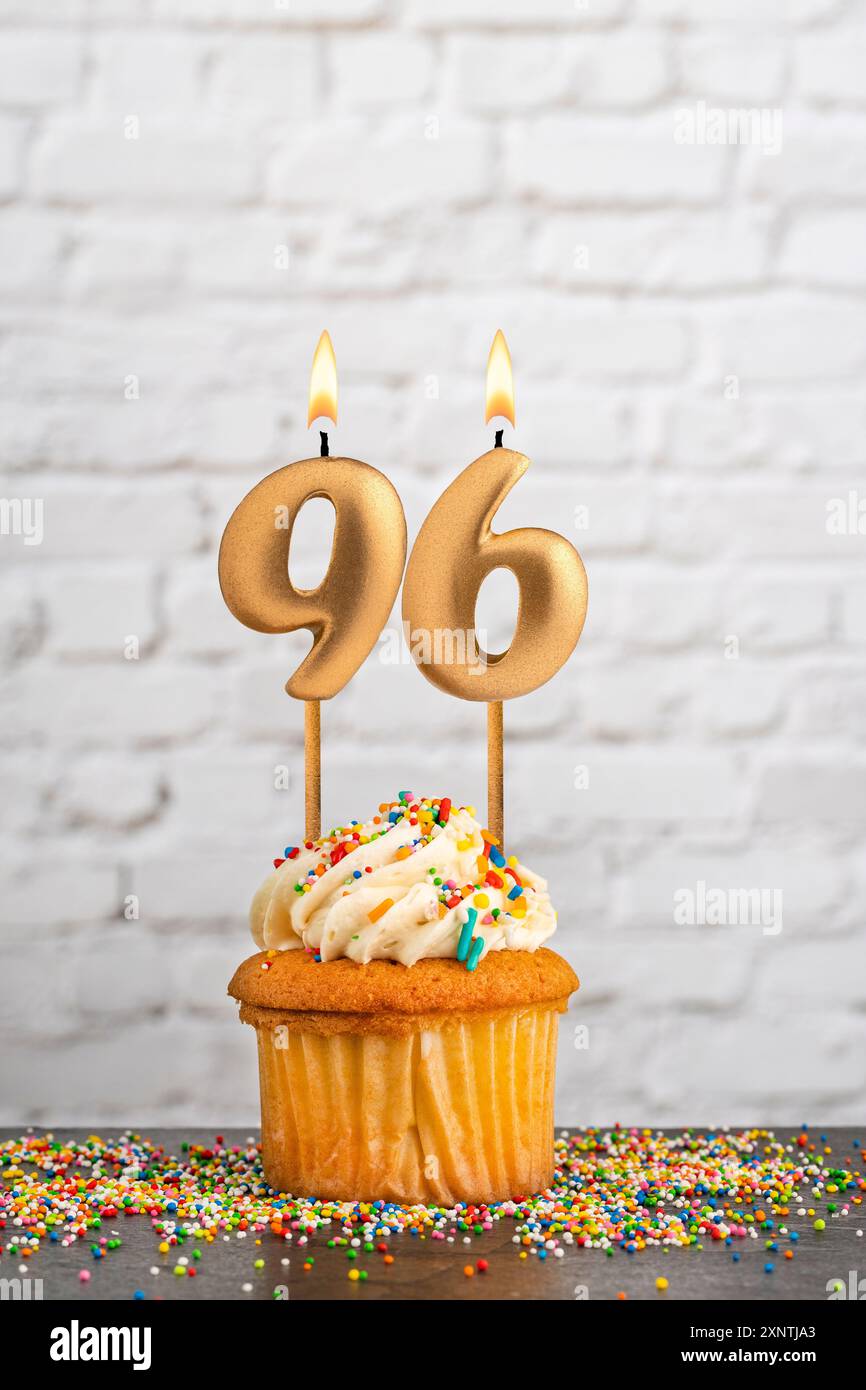 Cupcake with number 96 birthday candle - White block wall background ...