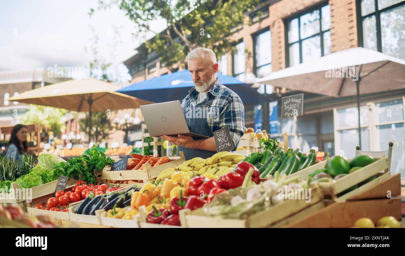 Farmer using laptop computer market hi-res stock photography and images ...