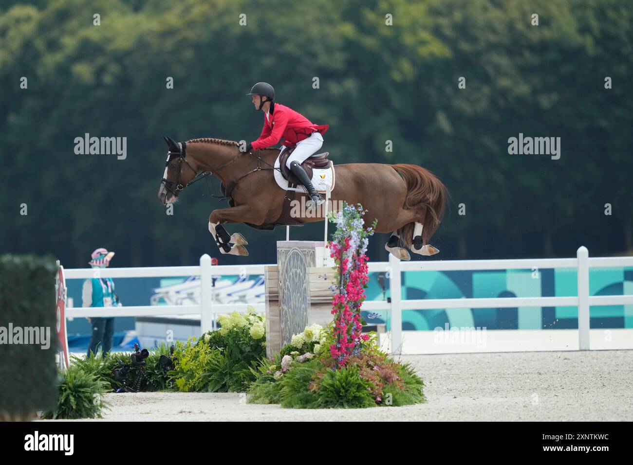 Belgium's Gilles Thomas riding Ermitage Kalone clears a hurdle during ...