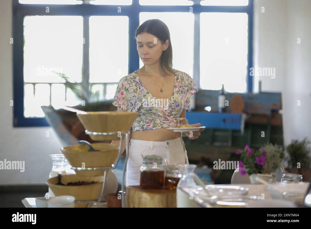 Woman taking food from a buffet line Stock Photo - Alamy